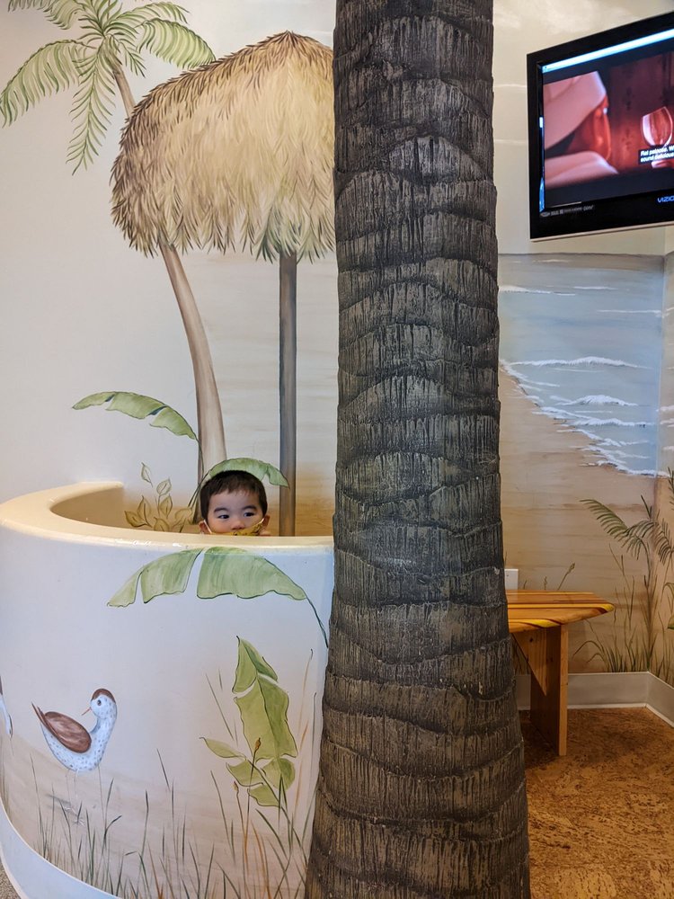 Cute waiting lounge with TV screens - Yelp