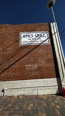 Opas Grill - a sign on a brick building - Tucson, AZ